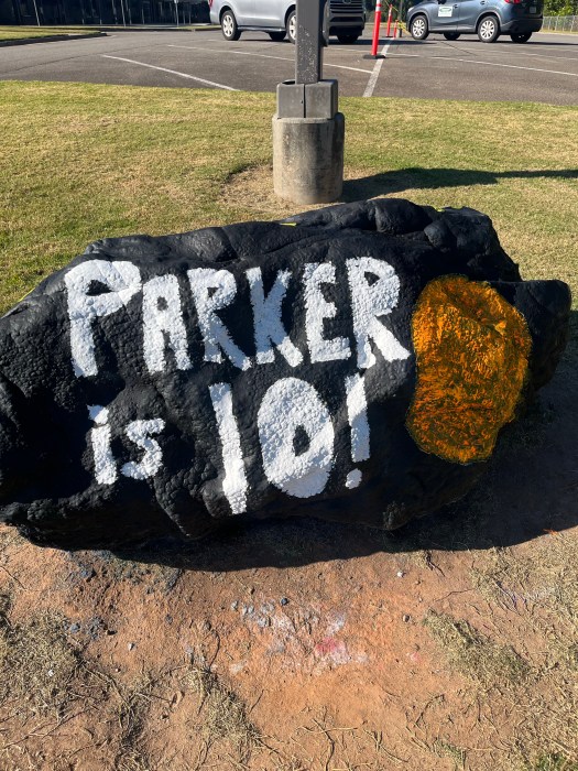 Painting a Message on a School Rock