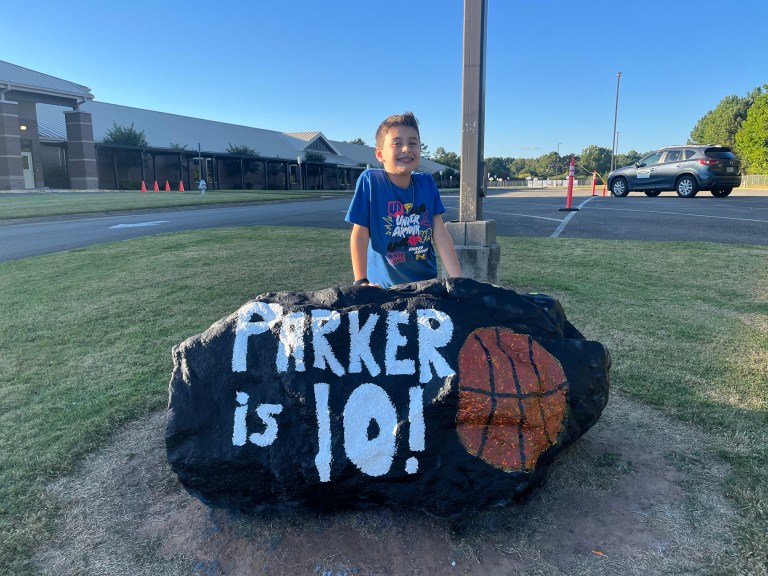 Painting a Message on a School Rock